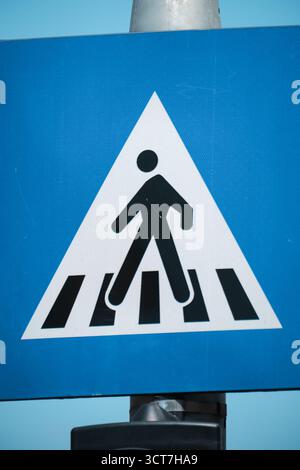 Traffic indicating sign, a blue crosswalk sign for pedestrians crossing ...