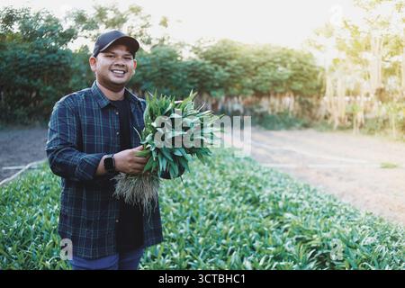 *Happy smart farmer holding fresh swamp Stock Photo - Alamy