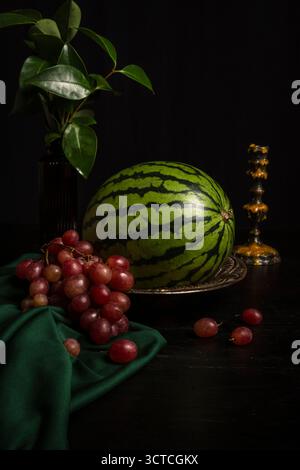 Cut watermelon with grapes on the table. Consumption of fruit on ...