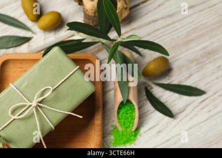 Soap bar, green olives and sea salt on color background Stock Photo - Alamy