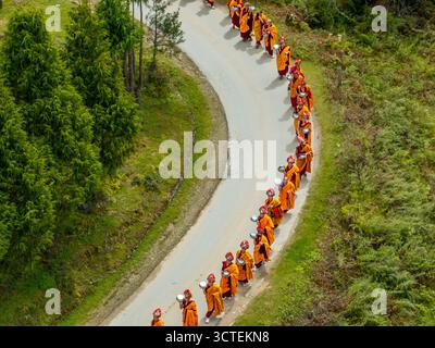 Phobjikha, Bhutan - 21 September 2025: View of monks processing along a ...