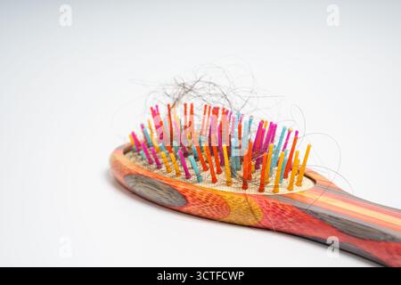 Hair brush with strands on wooden background Stock Photo - Alamy