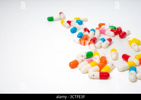 Many scattered colorful pills on blue background. Pharmaceutical ...