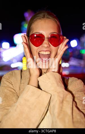 Portrait of a young woman on a funfair at night Stock Photo - Alamy