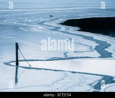 Beautiful pattern in the ice with reflecting clouds Stock Photo - Alamy