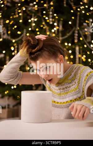 new year. amazed teen girl with red new year present in studio. teen ...