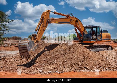 Crawler excavator bucket digging ground during earthmoving works at ...