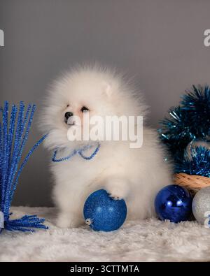 Blue Christmas toy ball among New Year's tinsel. Abstract background or ...