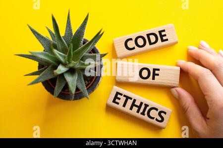 Code of ethics symbol. Wooden blocks with words 'Code of ethics ...