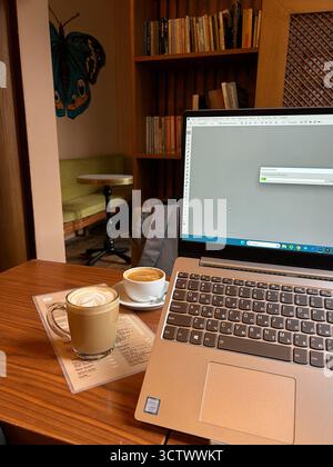 a cup of coffee stands on the table in gloomy and rainy weather. a cup ...