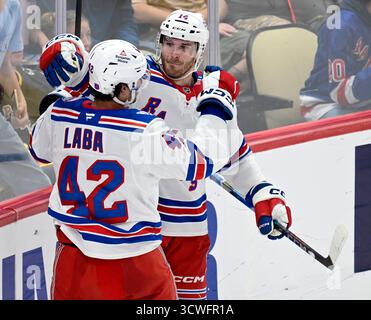 New York Rangers' Noah Laba (42) vies for the puck against Vancouver ...
