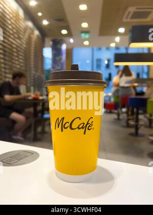 McDonalds paper drink cup with lid on yellow background, fast food ...