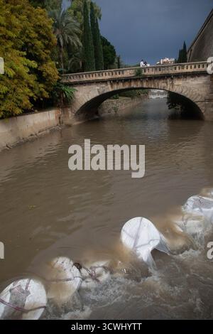 12 October 2025, Spain, Palma: On a rainy day in Mallorca, people with ...