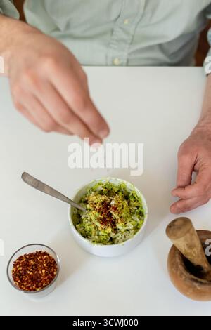 top view of salt, chilli flakes and powdered pepper in paper bags on ...