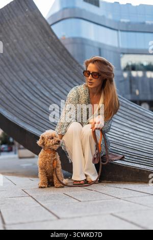 A beautiful red-haired woman at sidewalk cafe smiling thoughtfully ...
