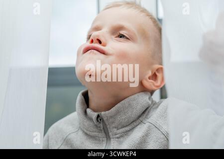 Photo portrait small boy thoughtful showing blank space with fingers ...
