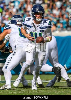 Seattle Seahawks quarterback Sam Darnold, right, greets a teammate ...