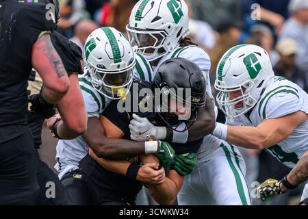Army quarterback Cale Hellums (3) is tackled by Air Force linebacker ...