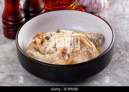 Roasted rabbit legs in cream sauce with capers Stock Photo - Alamy