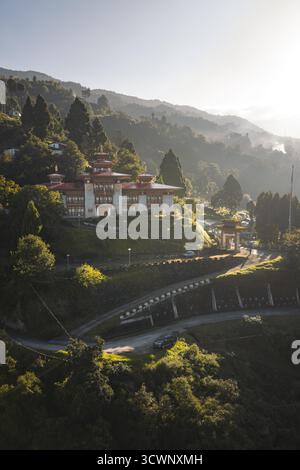 Aerial view of Trongsa Dzong, a majestic fortress with red roofs and ...