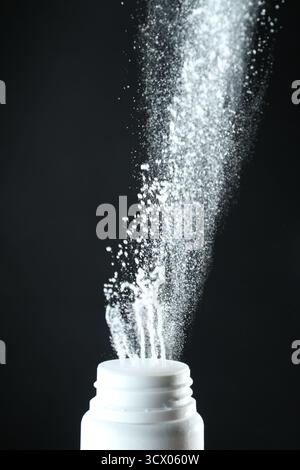 Container with talcum powder on black background, closeup Stock Photo ...