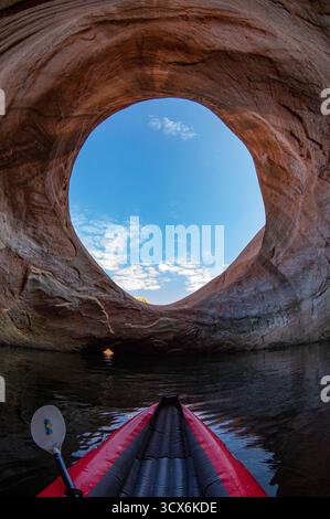 Kayaking inside Double-O arch, Rock Creek Bay, Lake Powell, Utah Stock ...