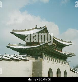 Snowy winter scene at historic palace by frozen lake. Royal Baths Park ...