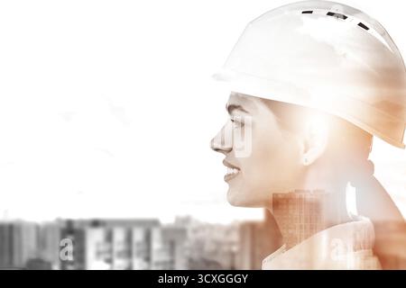 Engineer in hardhat, double exposure with buildings. Collage on white ...
