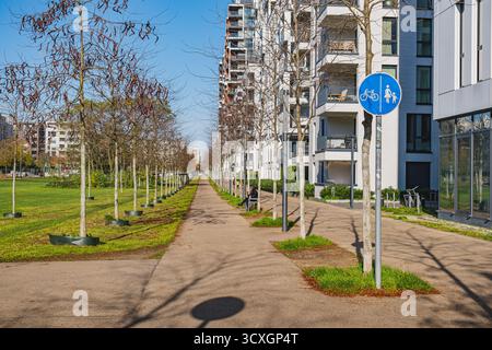 Pedestrian and bike path runs alongside modern apartment buildings ...