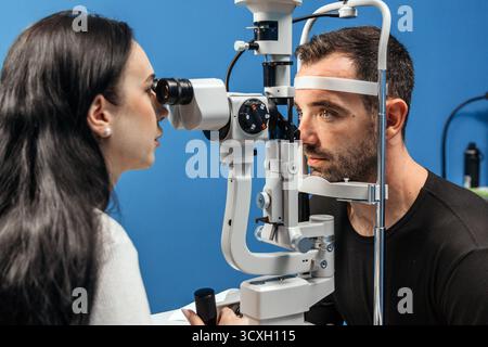 Professional ophthalmologist conducts eye treatment with medicine Stock ...