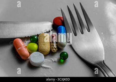 Close up of pills on plate. Dietary supplements. Variety pills. Vitamin ...