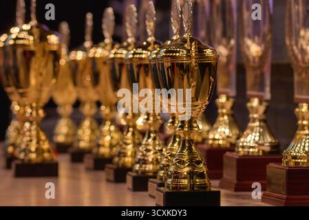 Award and victory concept. Row of golden cups of dance competition ...