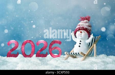 Festive New Year 2026 composition on snow with a red Christmas ornament ...