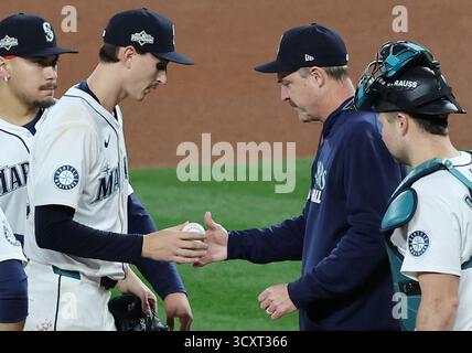 Seattle Mariners manager Dan Wilson, right, talks with home plate ...