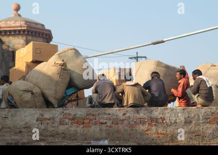 Indian daily wage laborers wait to get hired in Mumbai, India, Sunday ...