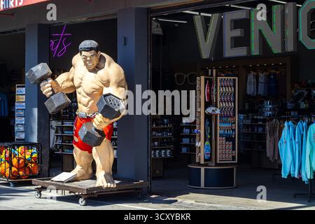 Statue of a bodybuilder lifting weights near Muscle Beach on the Venice ...
