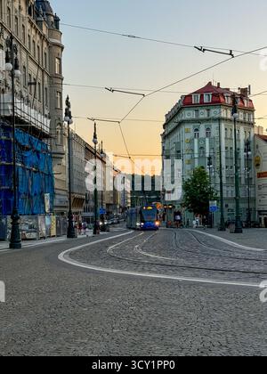 Charming European street with tram tracks, colorful buildings, and ...