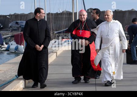 Pope Leo XIV, flanked by Cardinal Jose Tolentino de Mendonca, right ...
