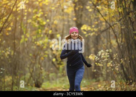 Woman running among autumn leaves Stock Photo - Alamy