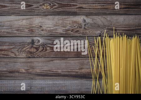 Yellow long spaghetti on a black background. Yellow italian pasta. Long ...