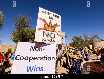 Protesters hold “No Kings” signs during a political demonstration in ...