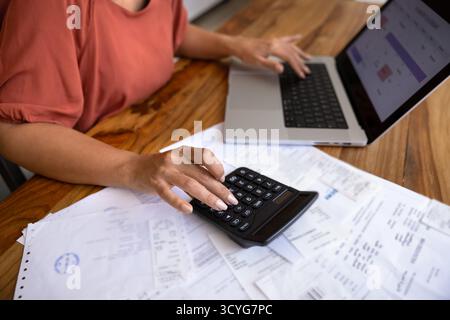 Cropped shot of young professional businesswoman working on her project ...