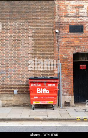 Red Biffa wheelie bin for disposal of waste paper Stock Photo - Alamy