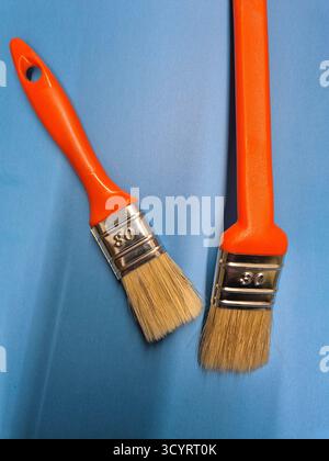 Pair of paint brushes with wood handles construction concept Stock ...