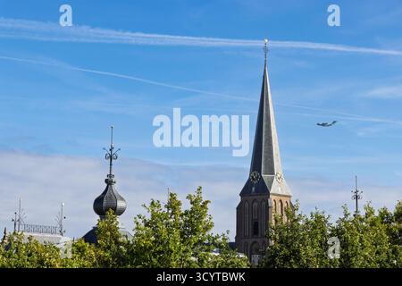 A low angle shot of an airplane flying against a cloudy blue sky Stock ...