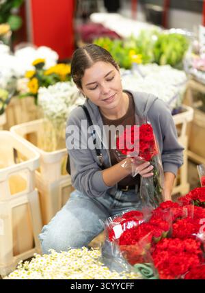 Female customer chooses a bouquet of carnations in flower shop Stock ...