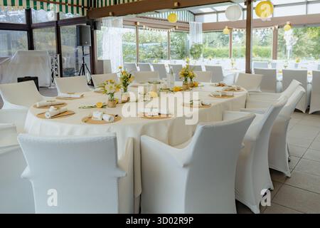 Elegant wedding reception setup with floral centerpieces and ...
