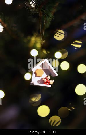 Close-up of a wooden house figurine in hand. Property insurance concept ...