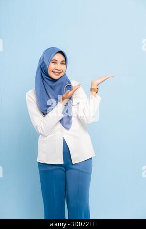 Asian adult woman doctor presenting human skeleton model during online ...