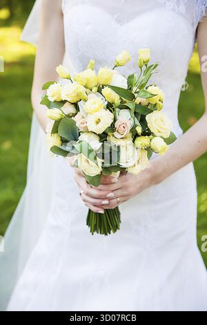 Beautiful wedding bouquet in hands of the bride Stock Photo - Alamy
